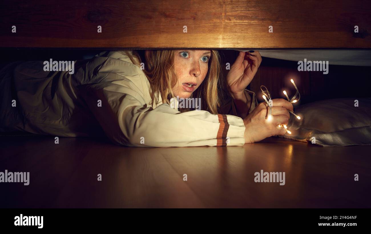 Woman searching under bed hi-res stock photography and images - Alamy