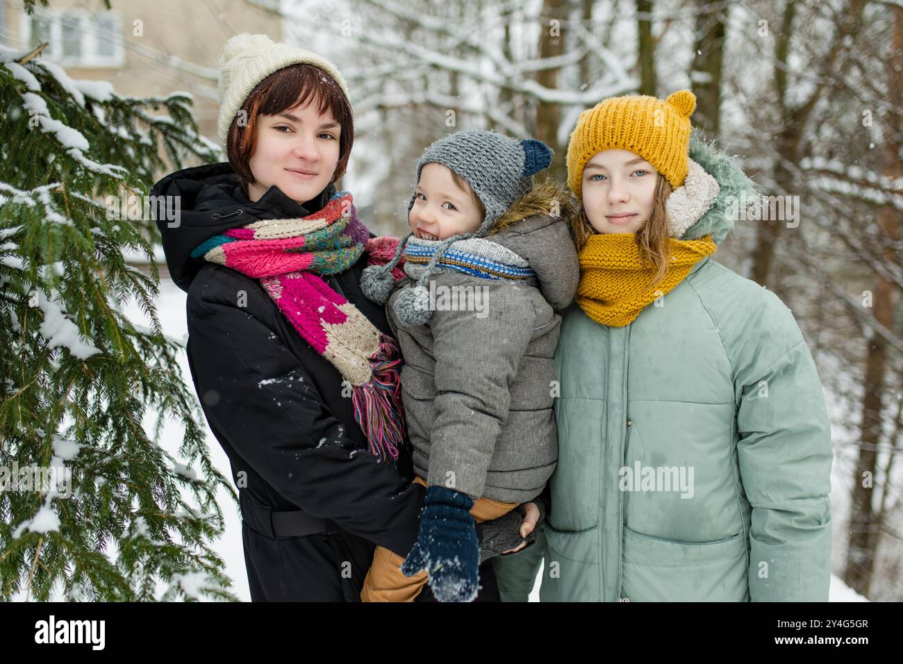 Two big sisters and their toddler brother having fun outdoors. Two ...