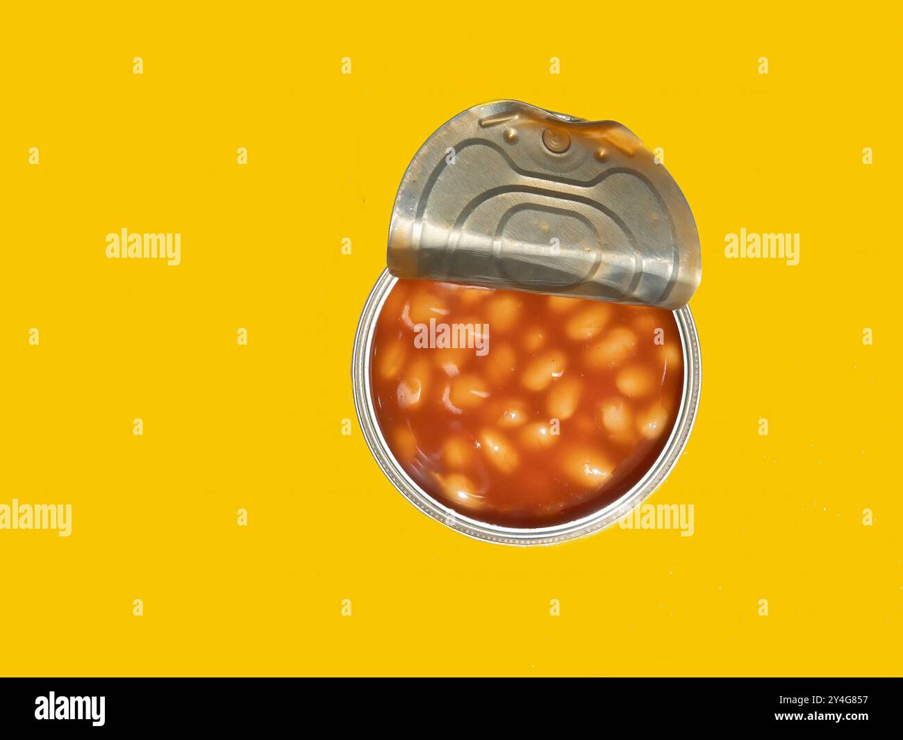 Open can of Baked Beans on a yellow background Stock Photo - Alamy