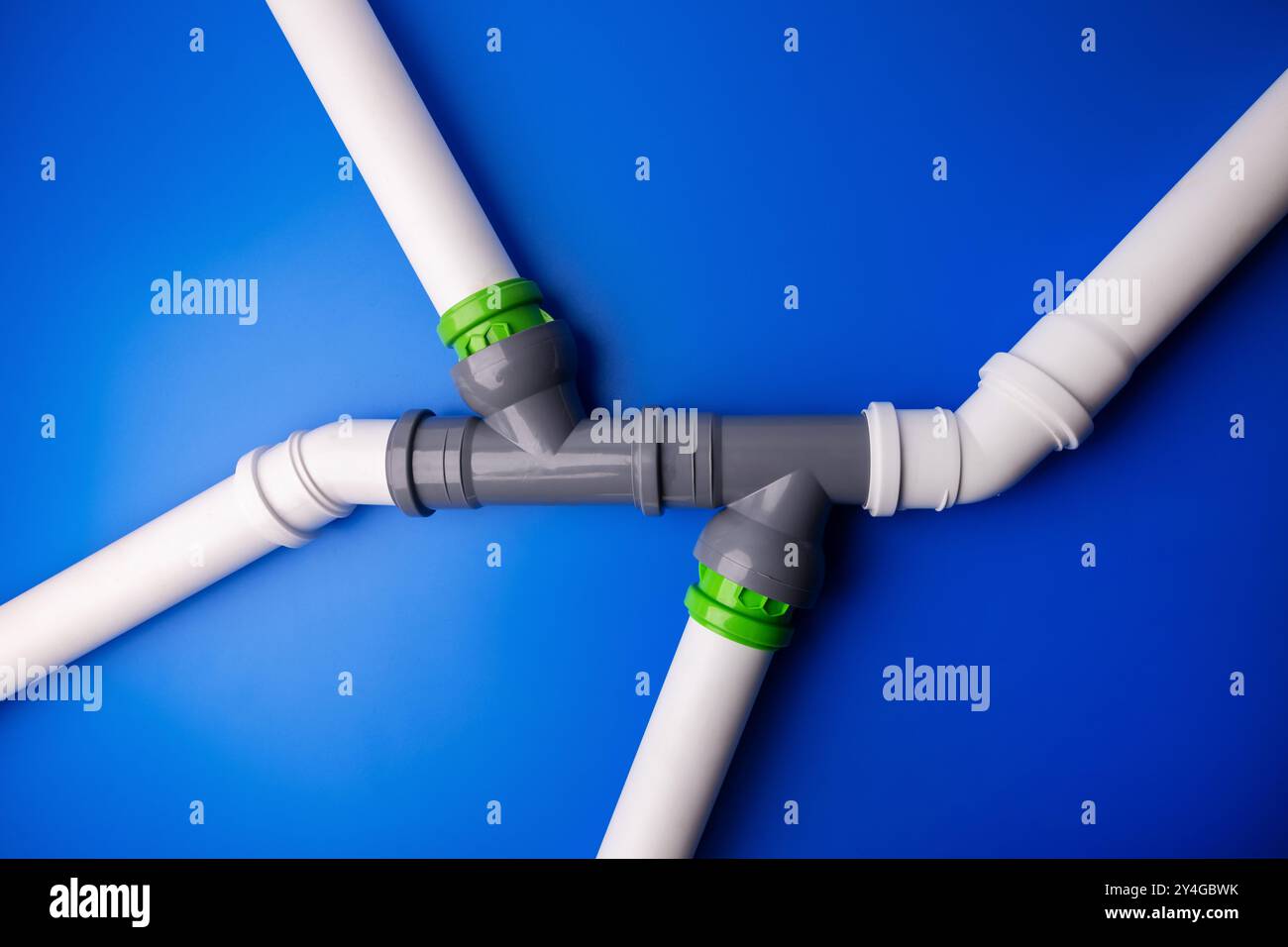 PVC drainage pipeline with adjustable connections on blue background ...