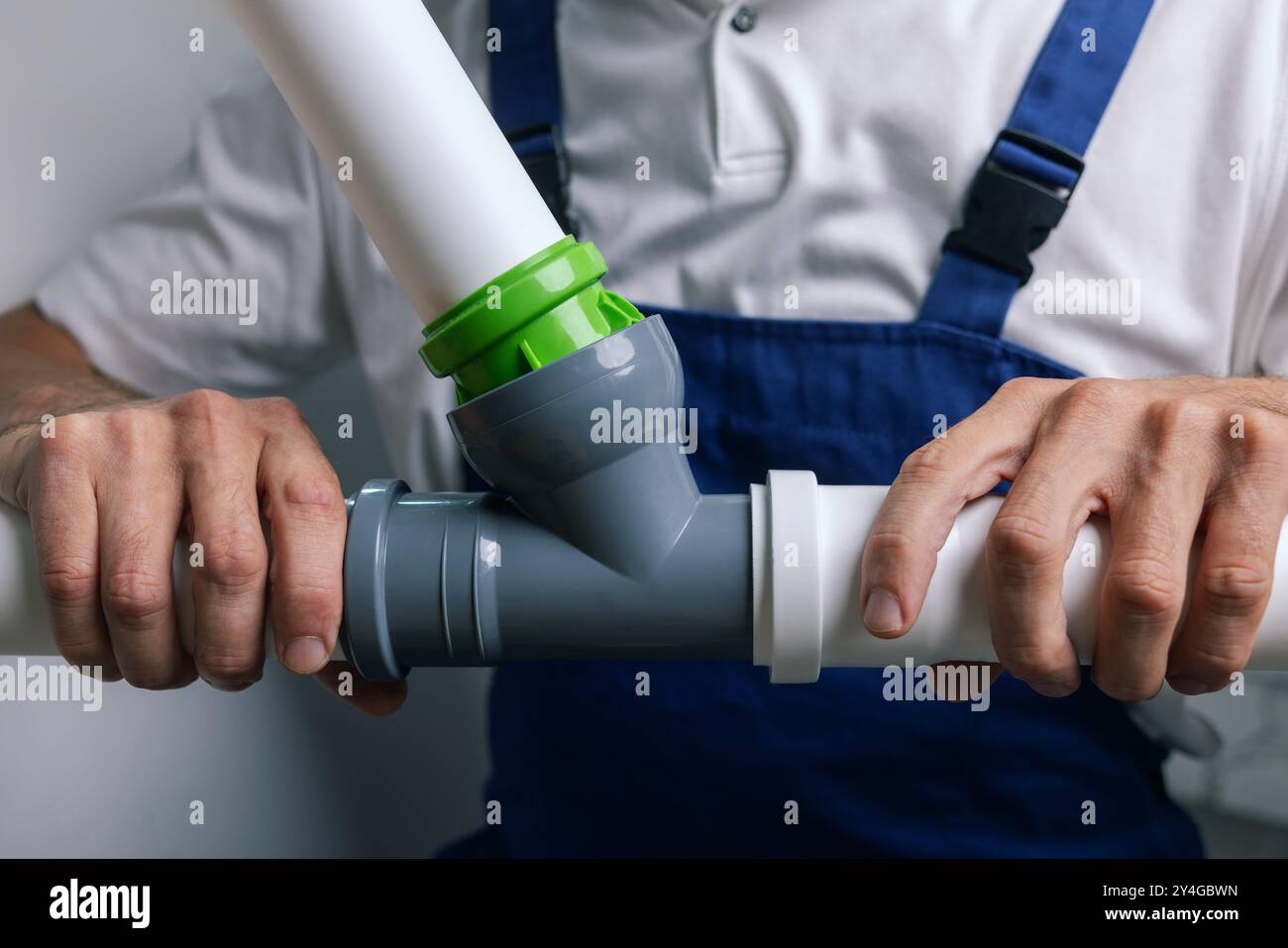 PVC pipes installation. plumber installing drain pipeline Stock Photo ...