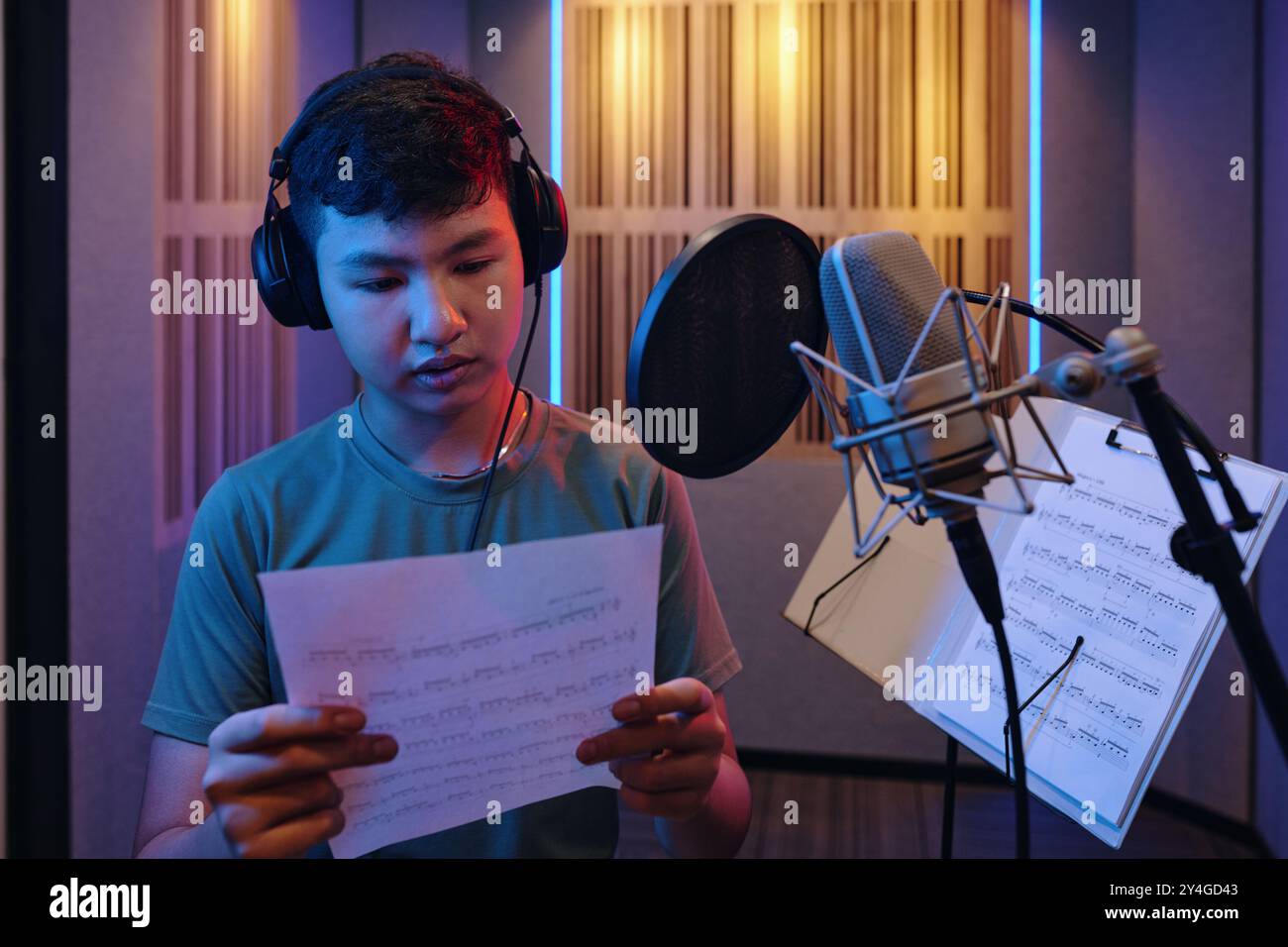 Young Boy Reading Sheet Music in Recording Studio Stock Photo - Alamy