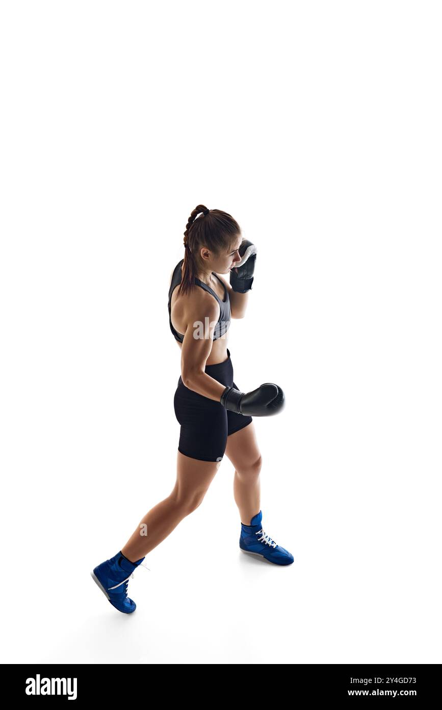 Full-length image of sportive young woman with fit body, boxing athlete ...