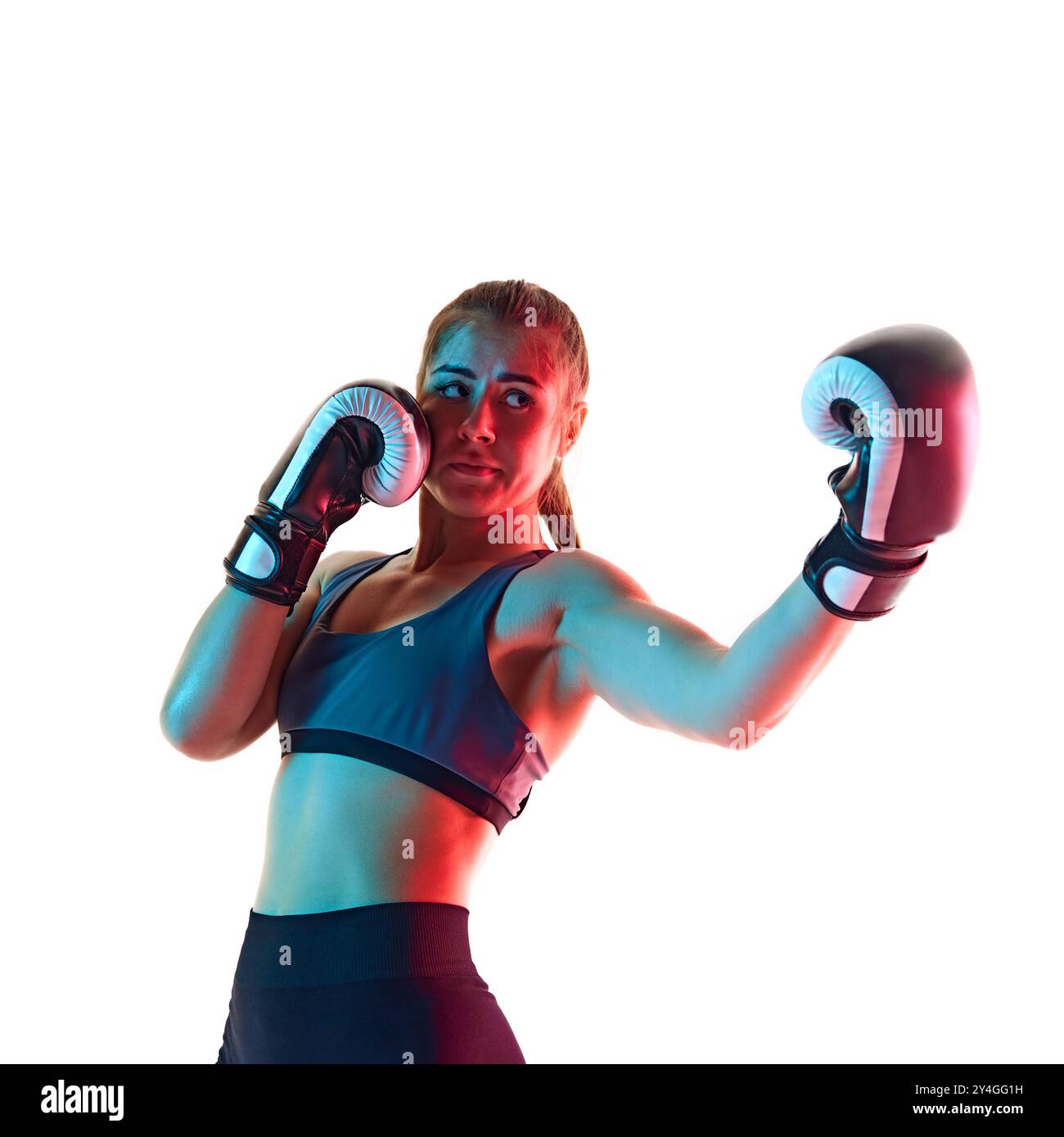 Uppercut punch. Concentrated young woman with fir sportive body, boxing ...