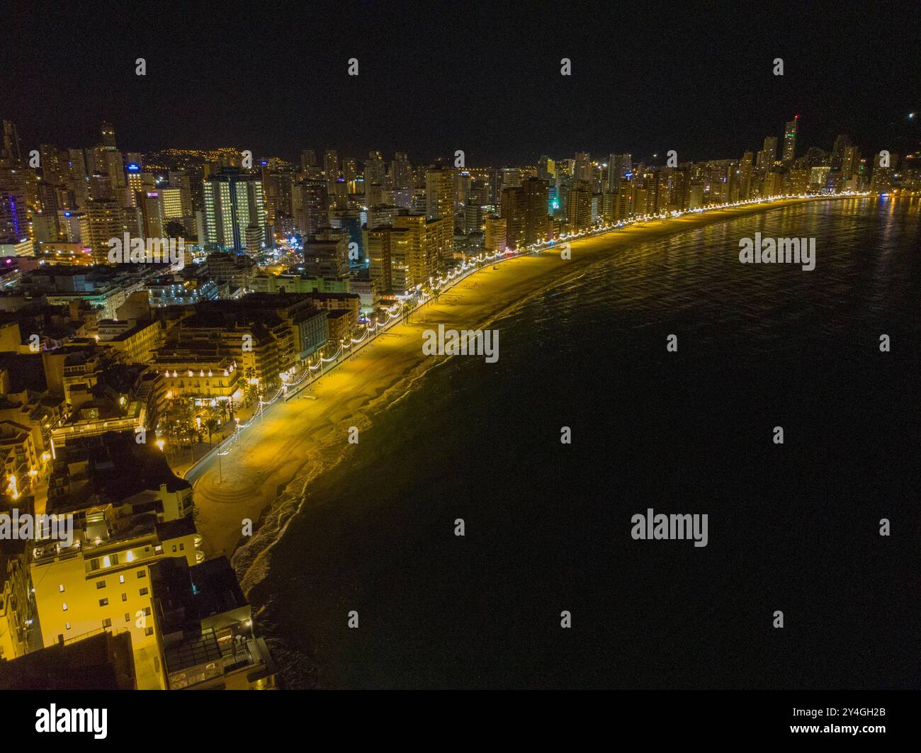 Night time aerial photo of the town of Benidorm in Spain and the beach ...