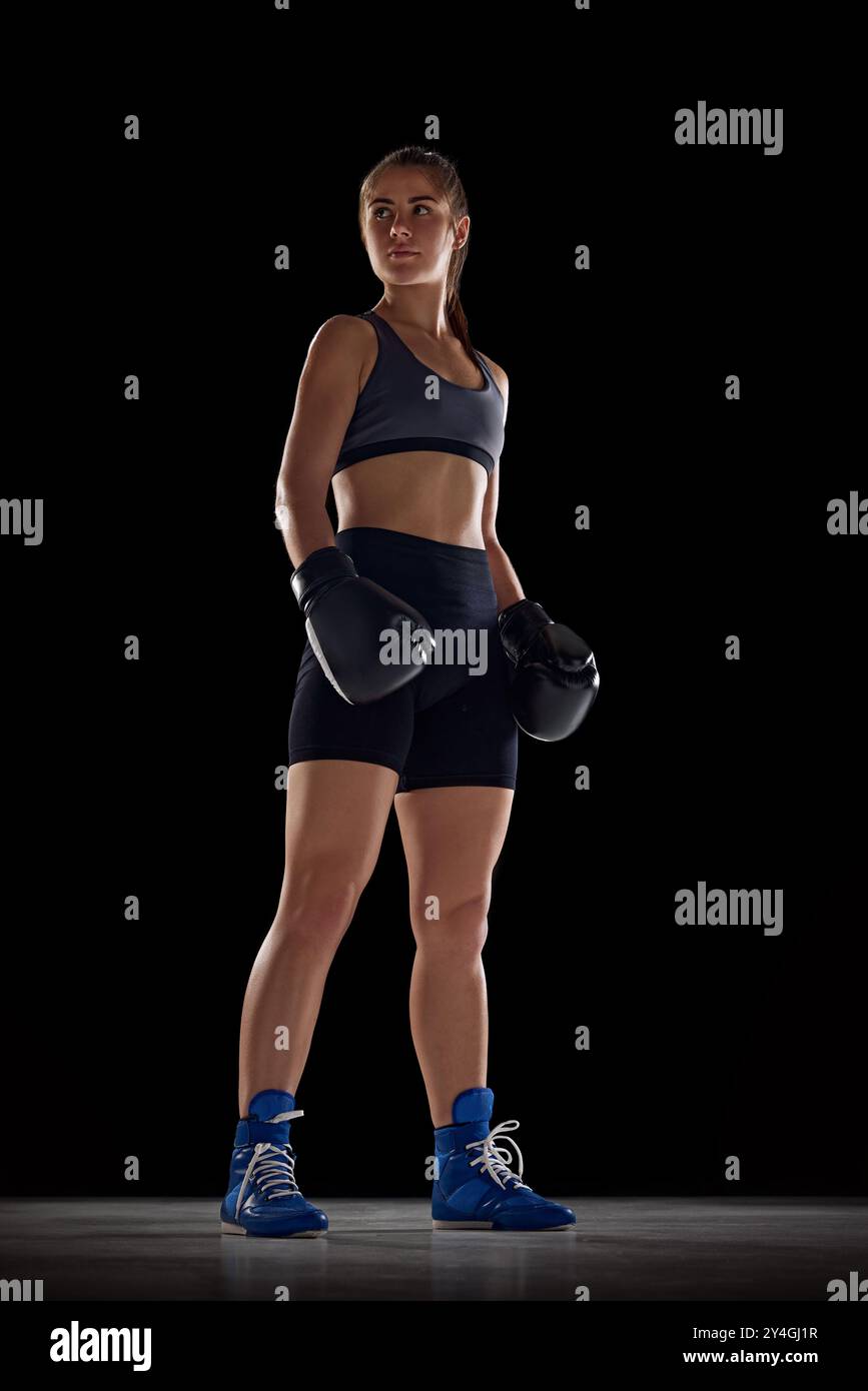 Full-length image of sportive young woman with fit body, boxing athlete ...