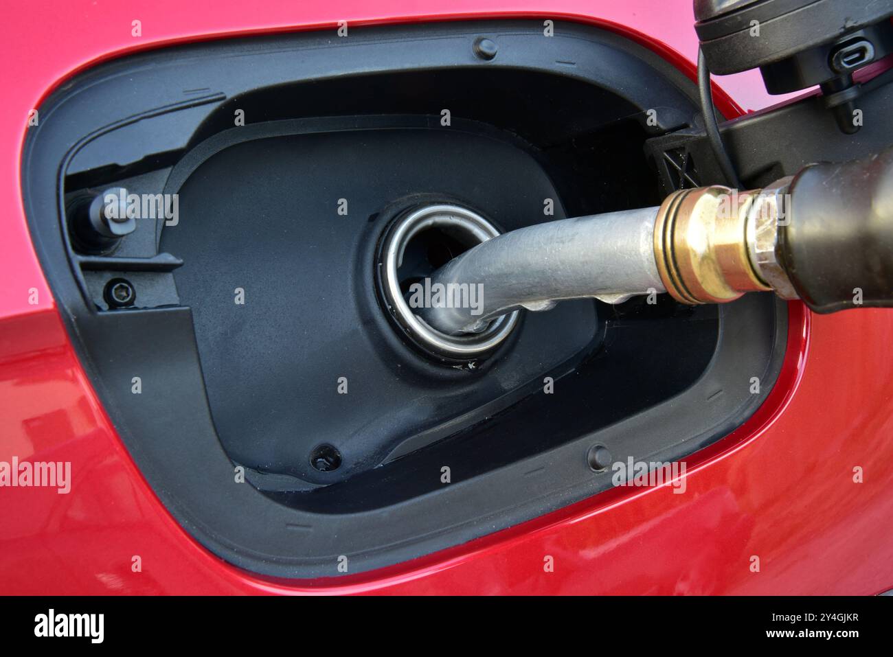 Refueling gun in tank filler. Fuel Nozzle in tank filler. Fuel pump in ...