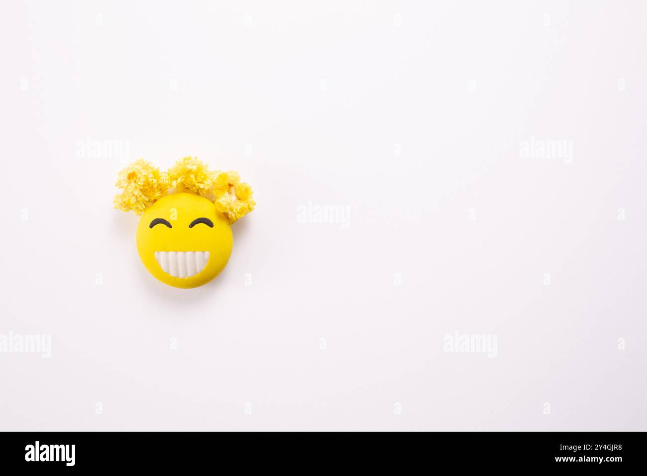 Smiling yellow face on white background. World smile day. Copy space ...