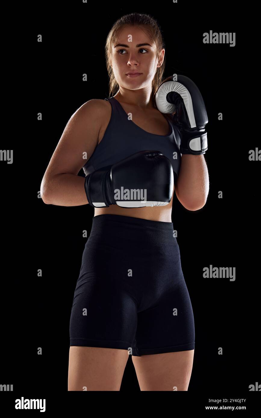 Portrait of beautiful young woman with sportive body, boxing athlete ...
