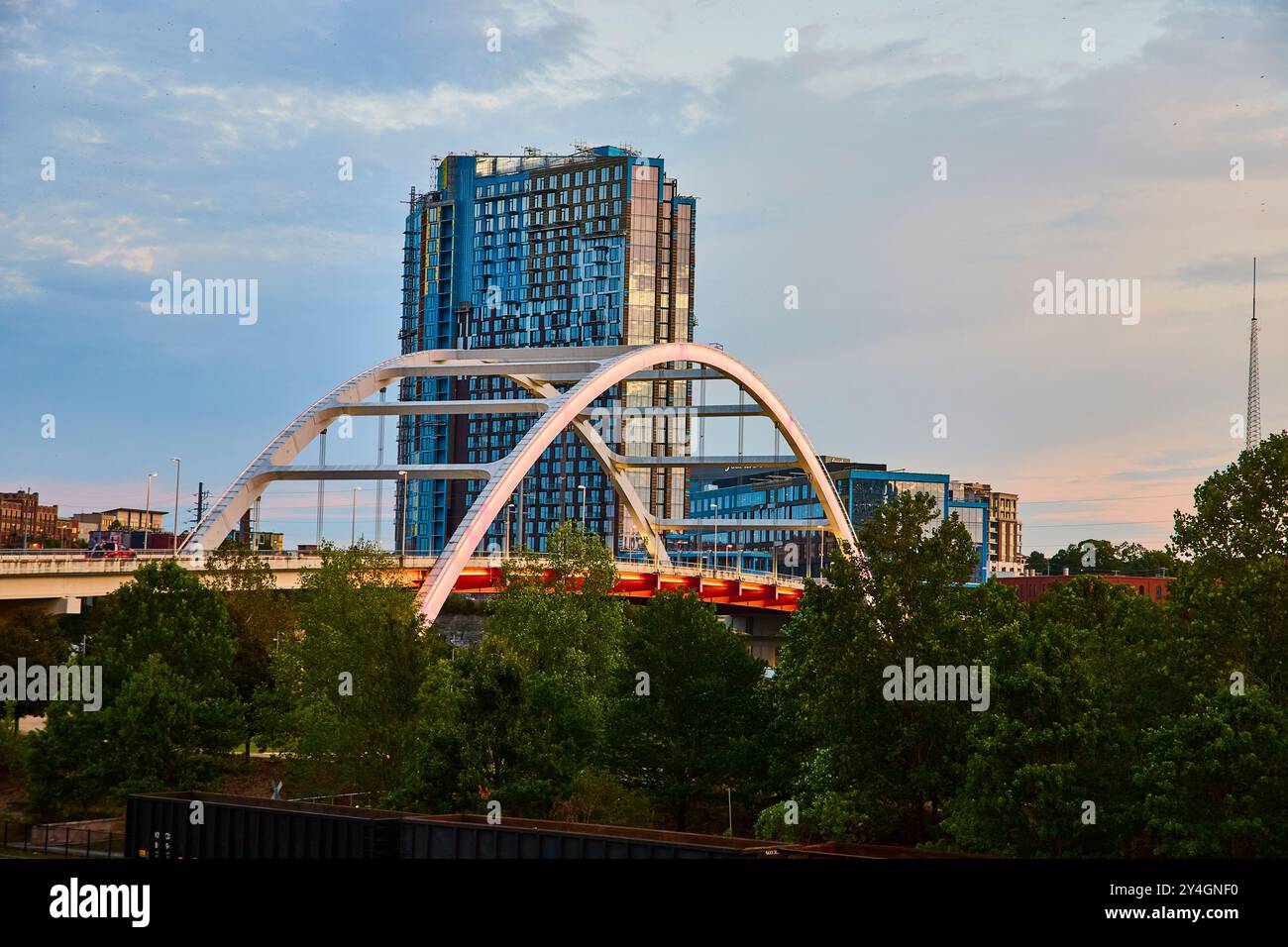 Modern White Arch Bridge and High-Rise with Greenery Aerial View Stock ...
