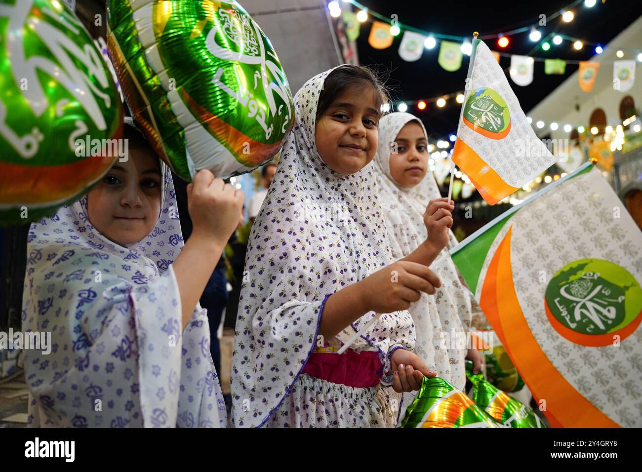 Children wearing traditional costumes participate in a celebration of ...