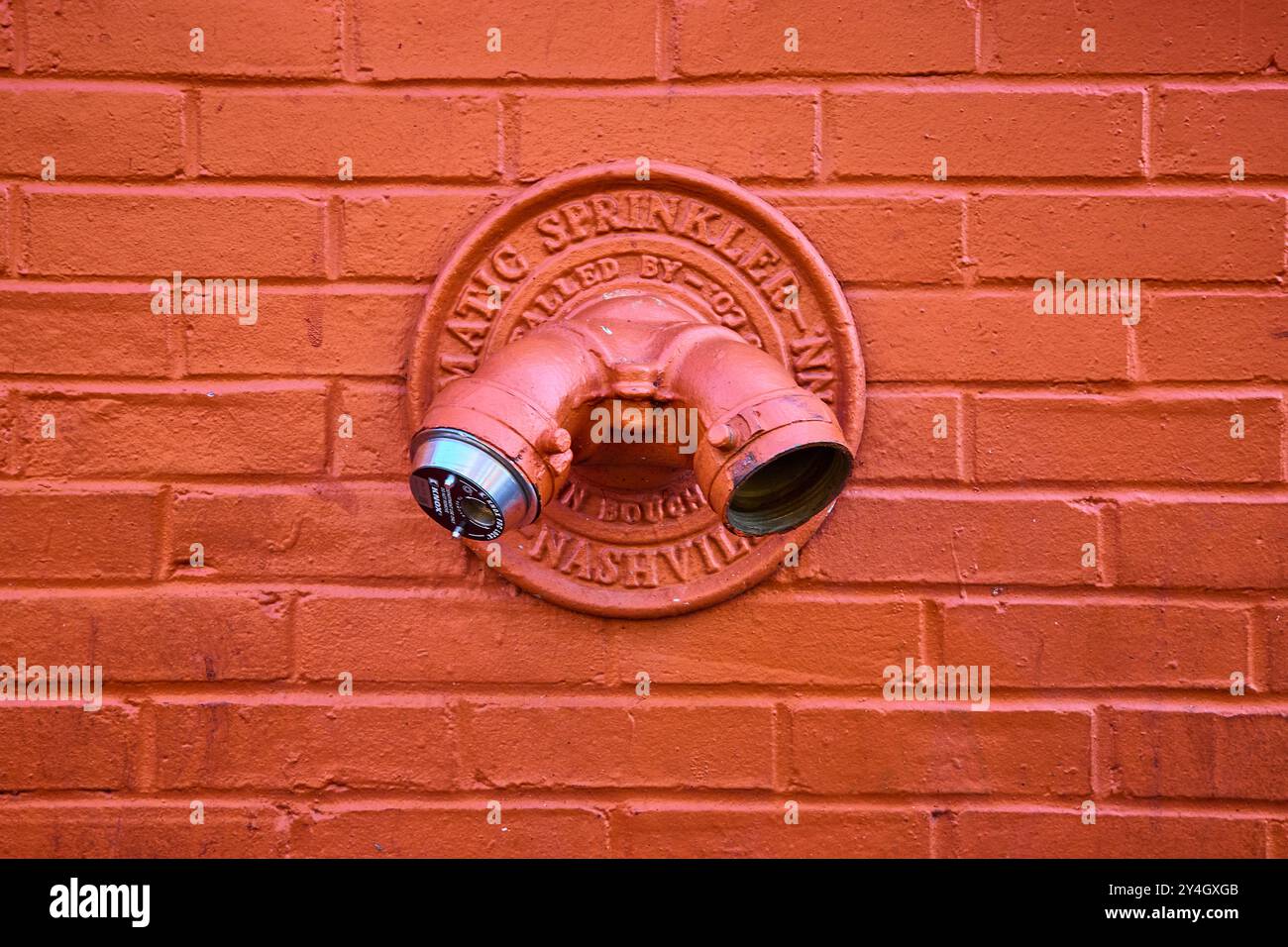 Orange Fire Department Connection on Brick Wall Close-Up Stock Photo ...