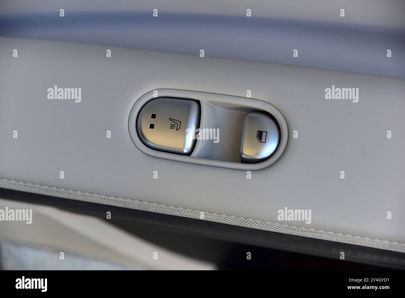 The button for raising the windows and the button for heating the seats ...