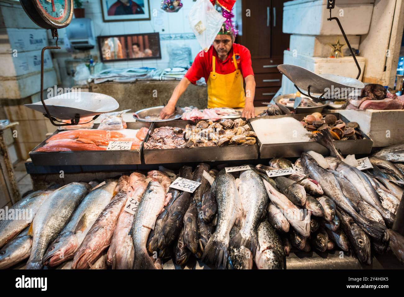 SANTIAGO, Chile — A vendor tends their stall at Mercado Central ...