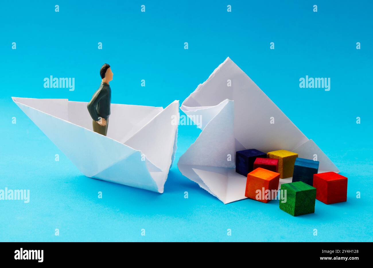Businessman on broken ship with lost cargo Stock Photo - Alamy