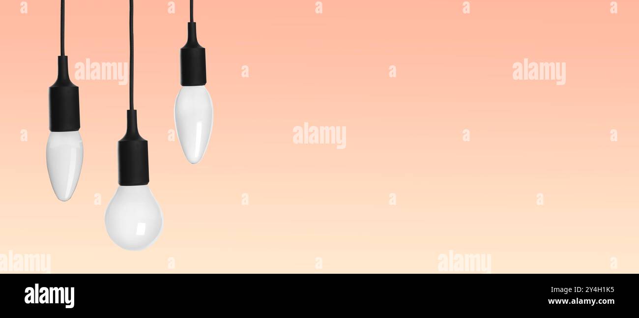 Different incandescent light bulbs on beige gradient background, banner ...
