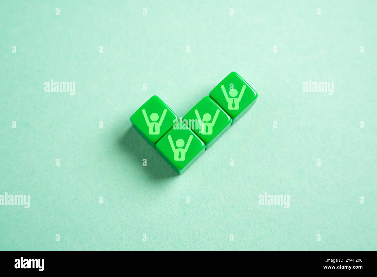 A green tick with symbols of jubilant team members. Achieve success ...