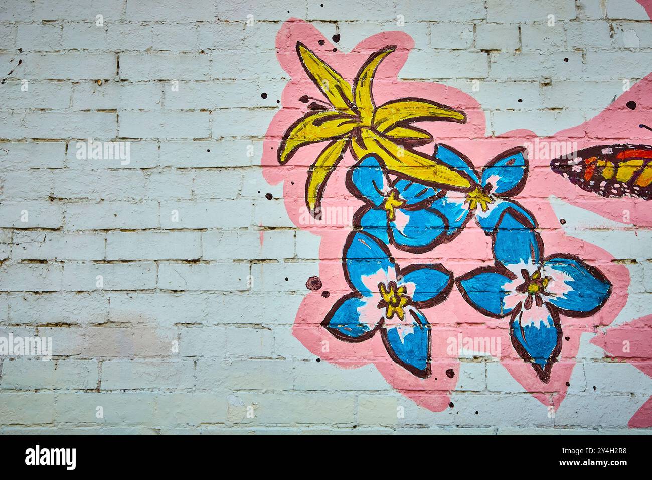 Vibrant Floral Mural with Butterfly on White Brick Eye-Level View Stock ...