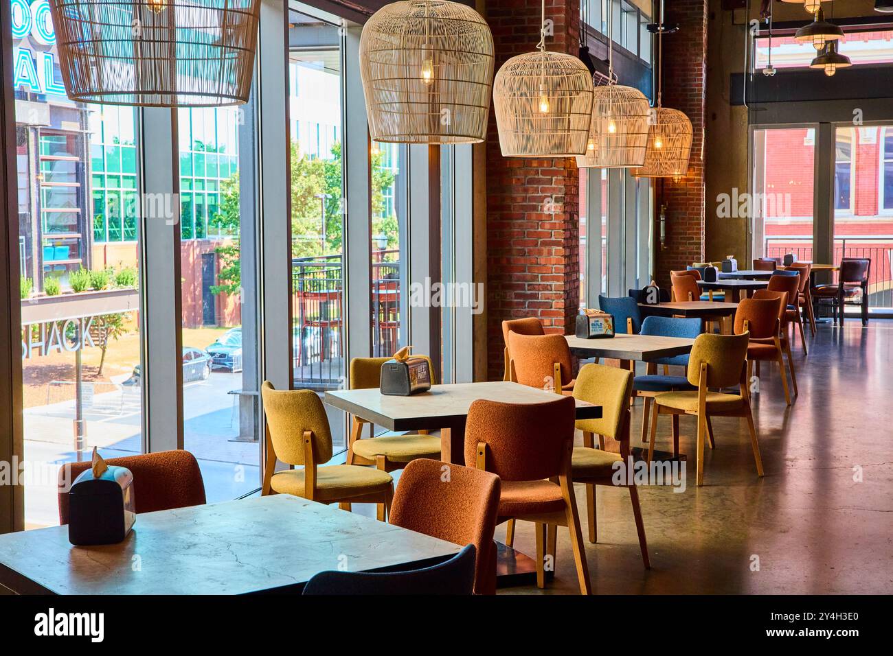 Modern Cafe Interior with Colorful Seating and Natural Light ...