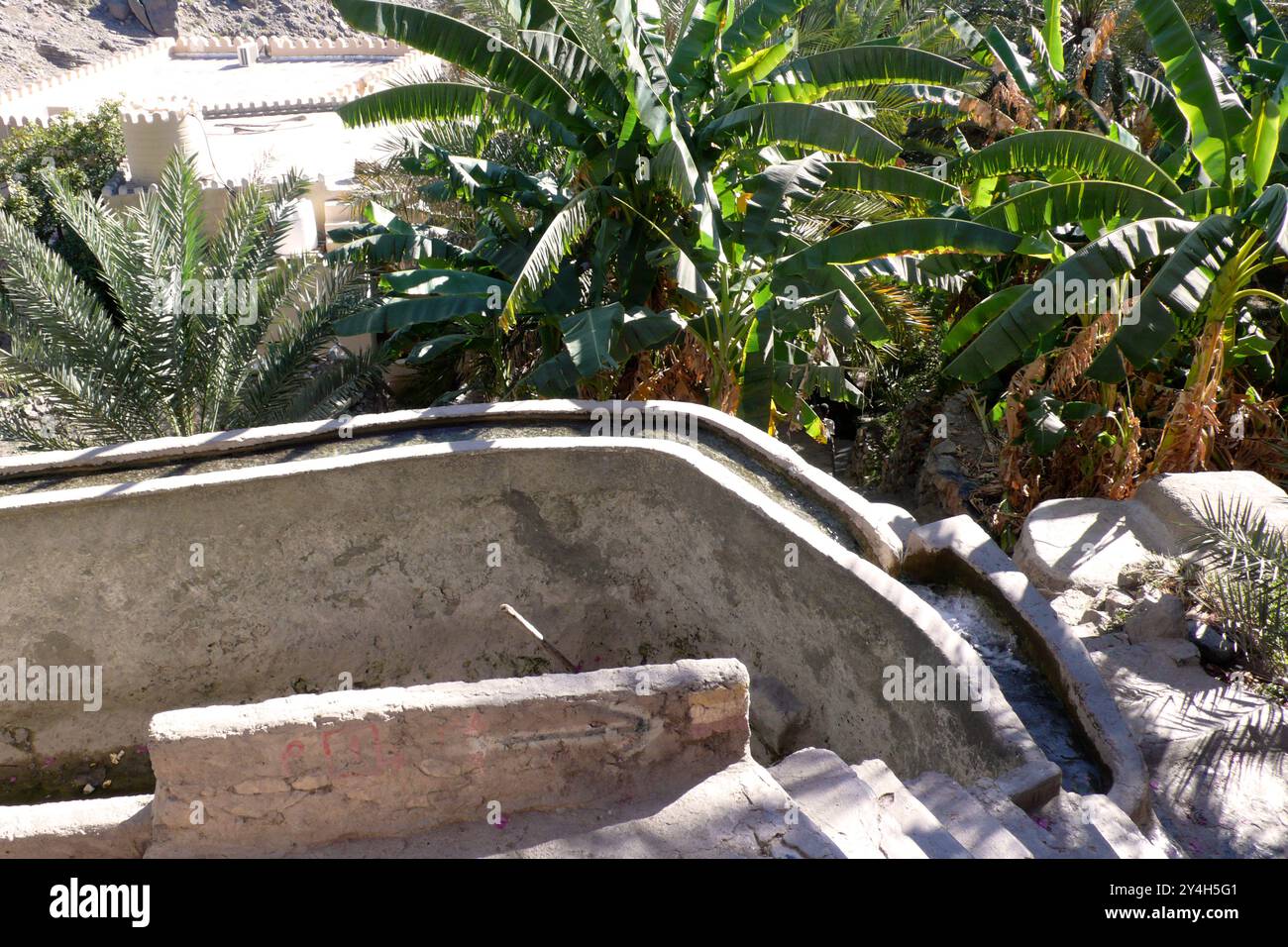 The falaj (typical small canal irrigation system) Misfah (Oman Stock ...