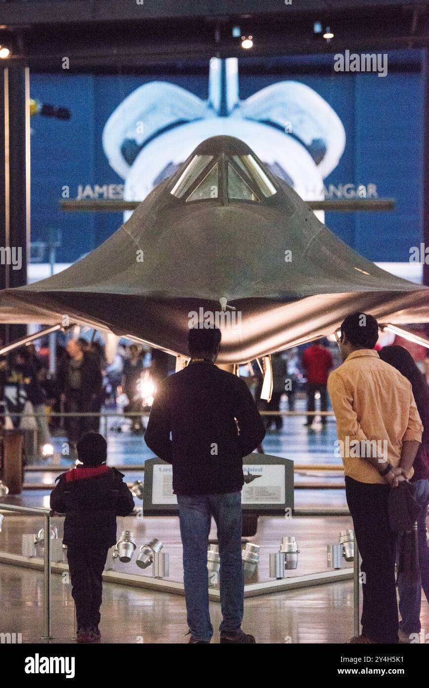 Visitors stand in front of the Lockheed SR-71 Blackbird on display at ...