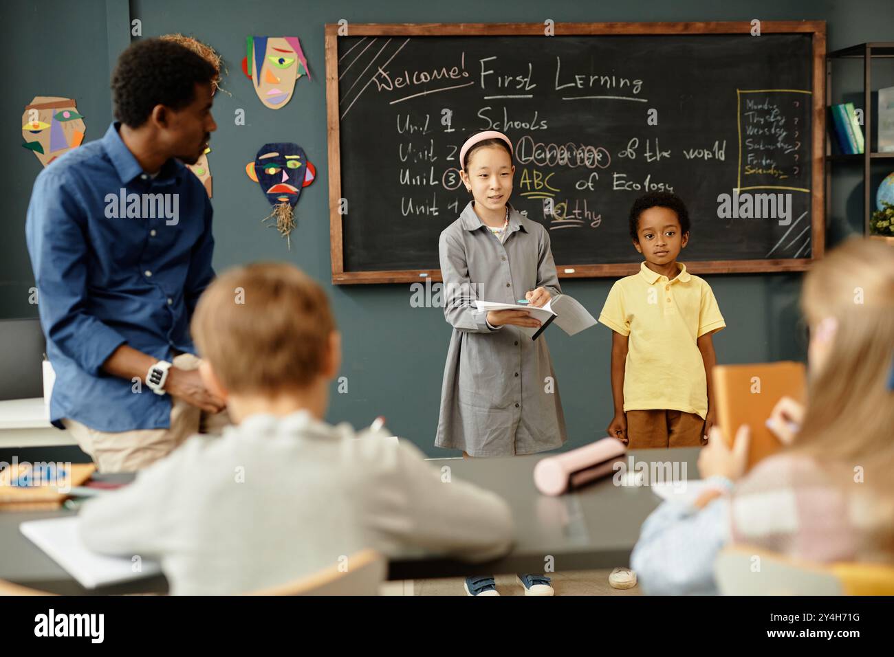 Adorable young students from diverse ethnic backgrounds presenting ...