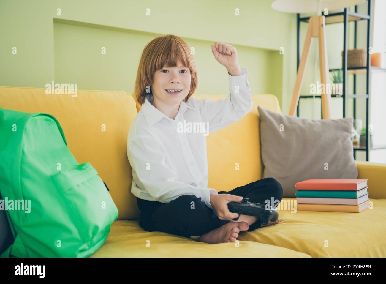 Portrait of cheerful positive little boy schoolkid enjoying free time ...