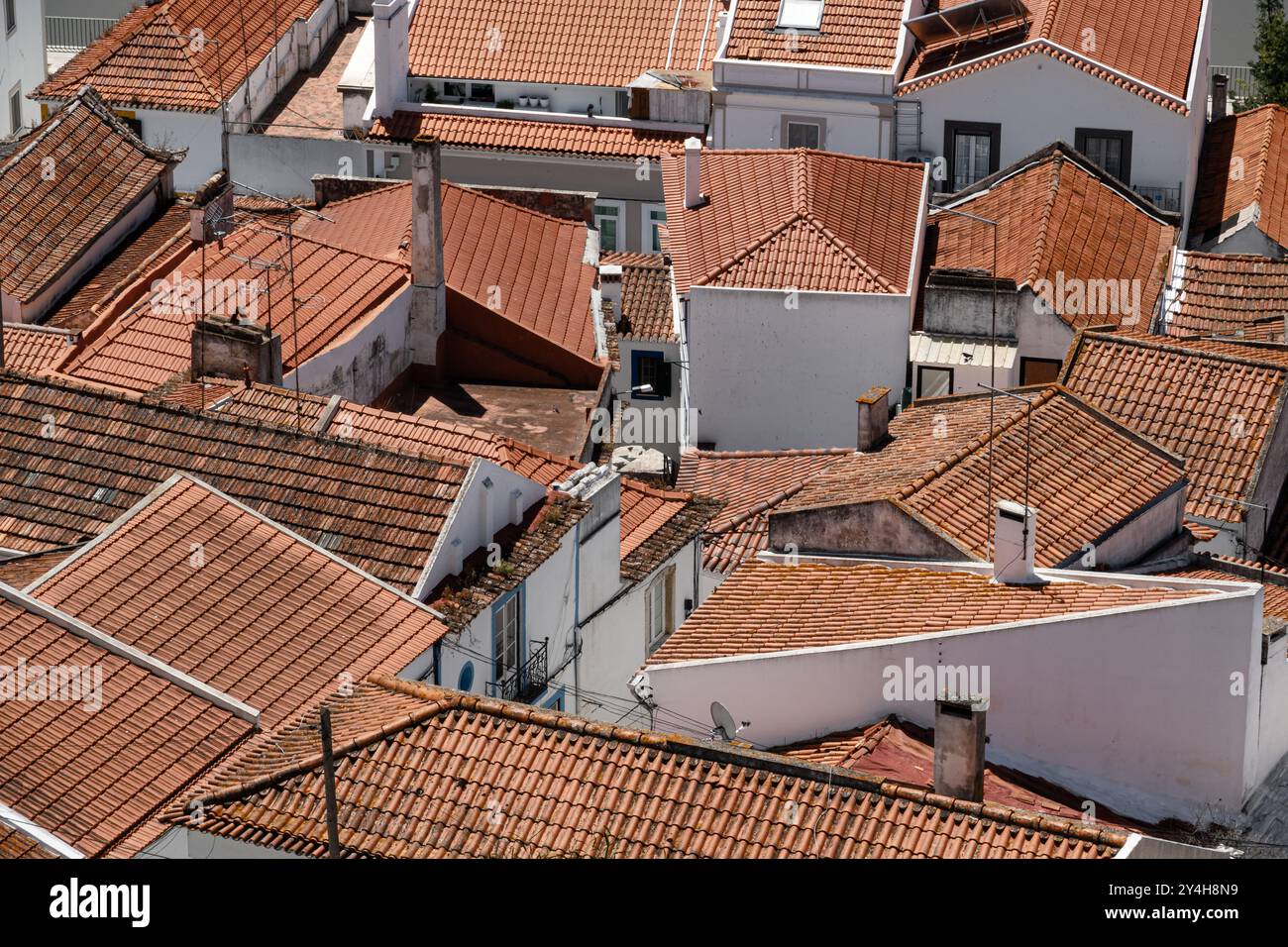 Red clay tile rooftops of whitewashed wall street houses in urban ...