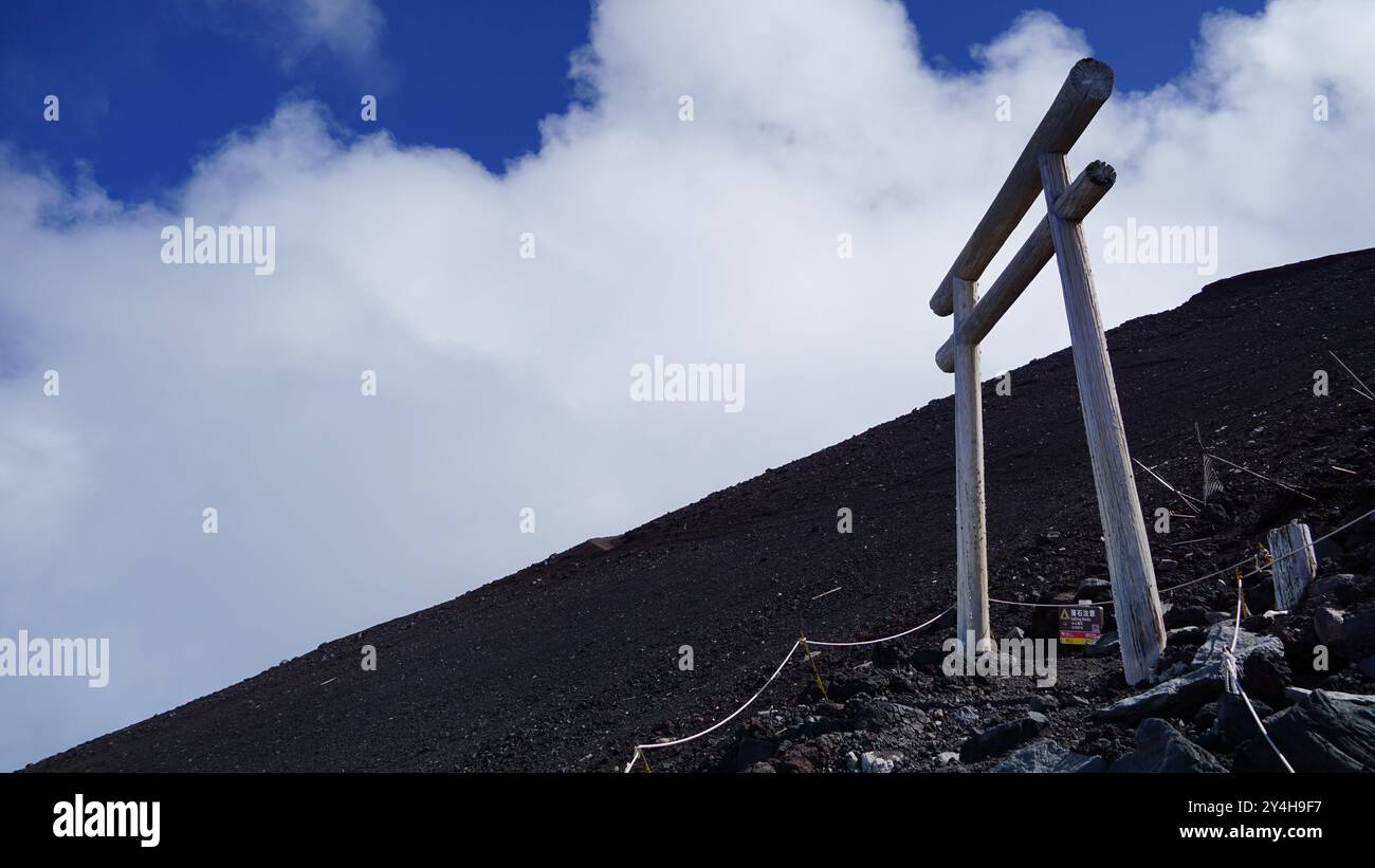 White tori gates in Mt. Fuji in Japan with rocks Stock Photo - Alamy