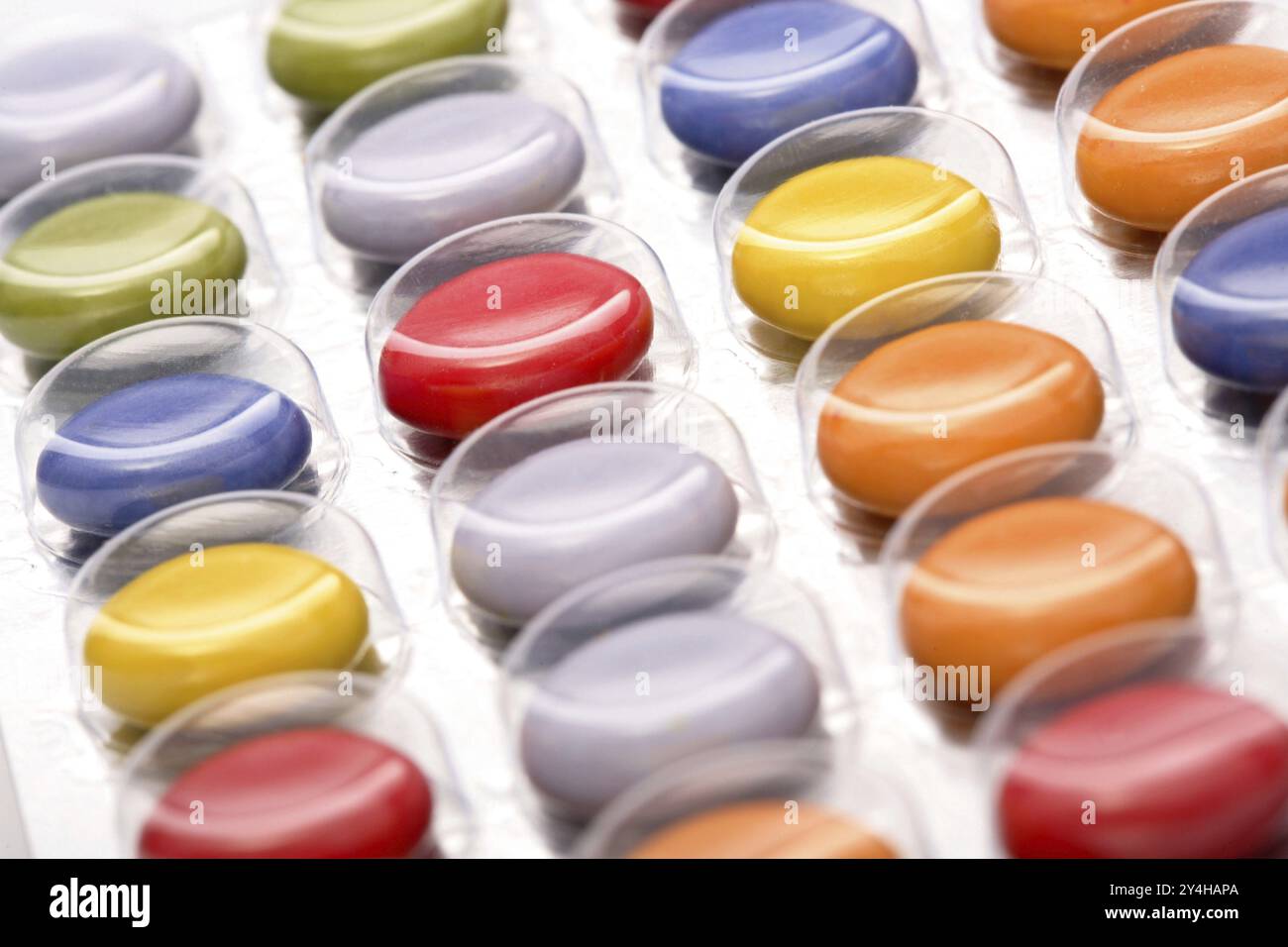 Colourful tablets packed in plastic, tablet addiction, drug addiction ...