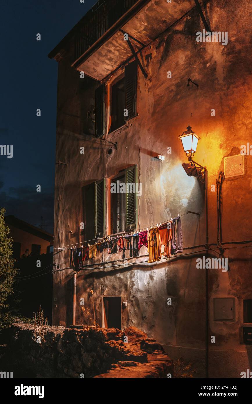 Dilapidated house wall with clothesline, house, evening mood, evening ...