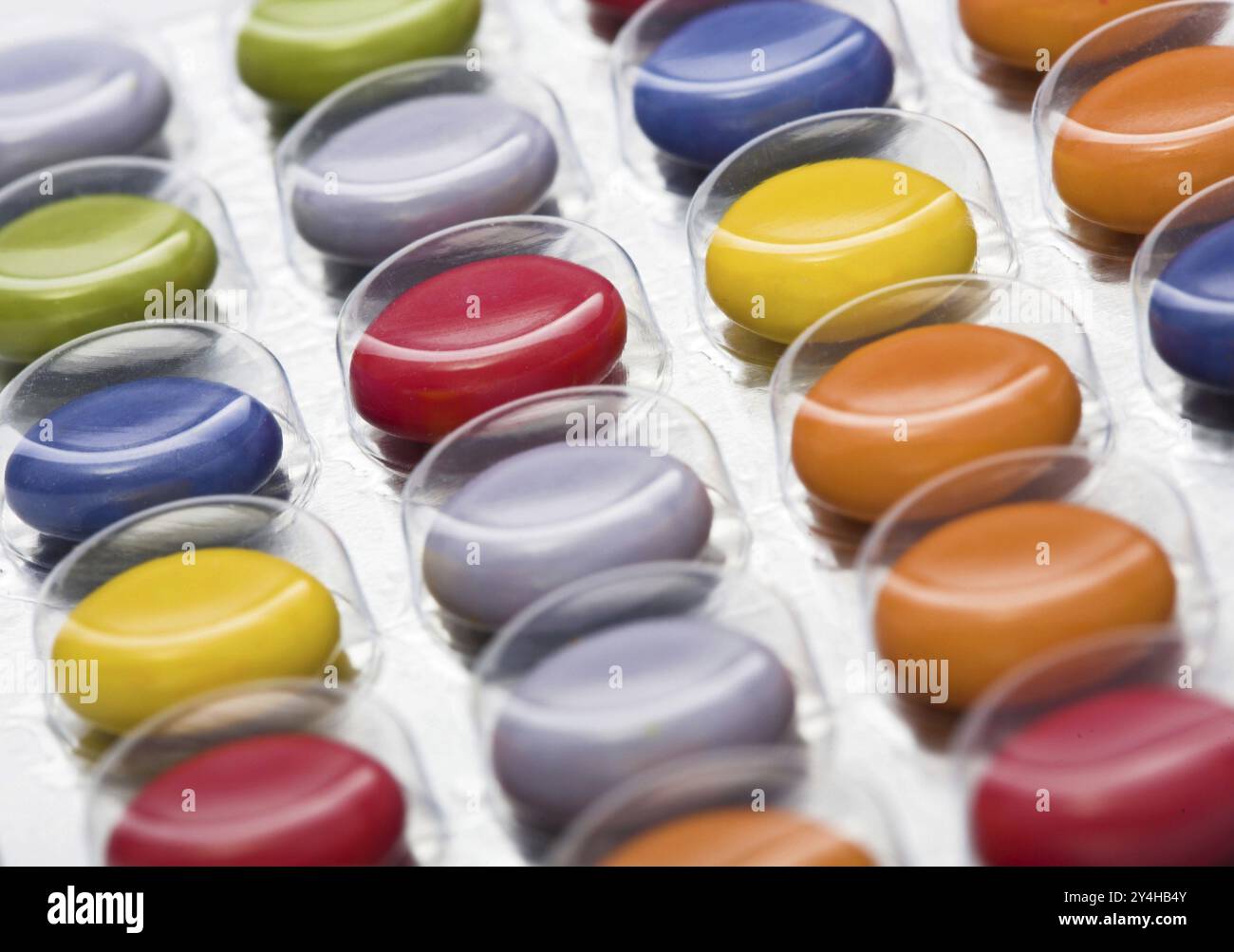Colourful tablets packed in plastic, tablet addiction, drug addiction ...