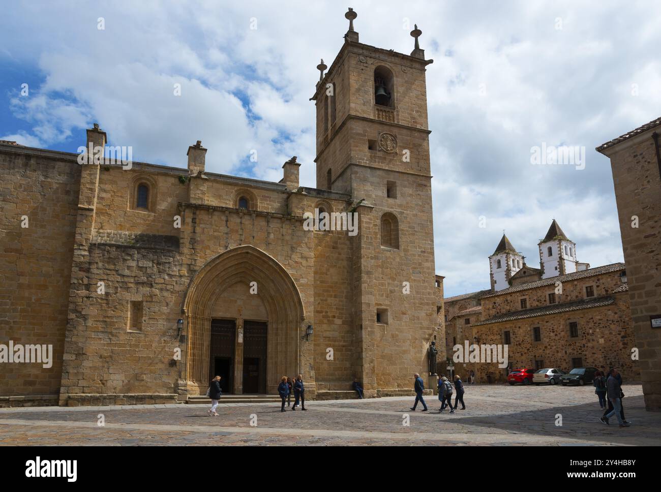 Large square with Gothic church and historic buildings under a blue sky ...
