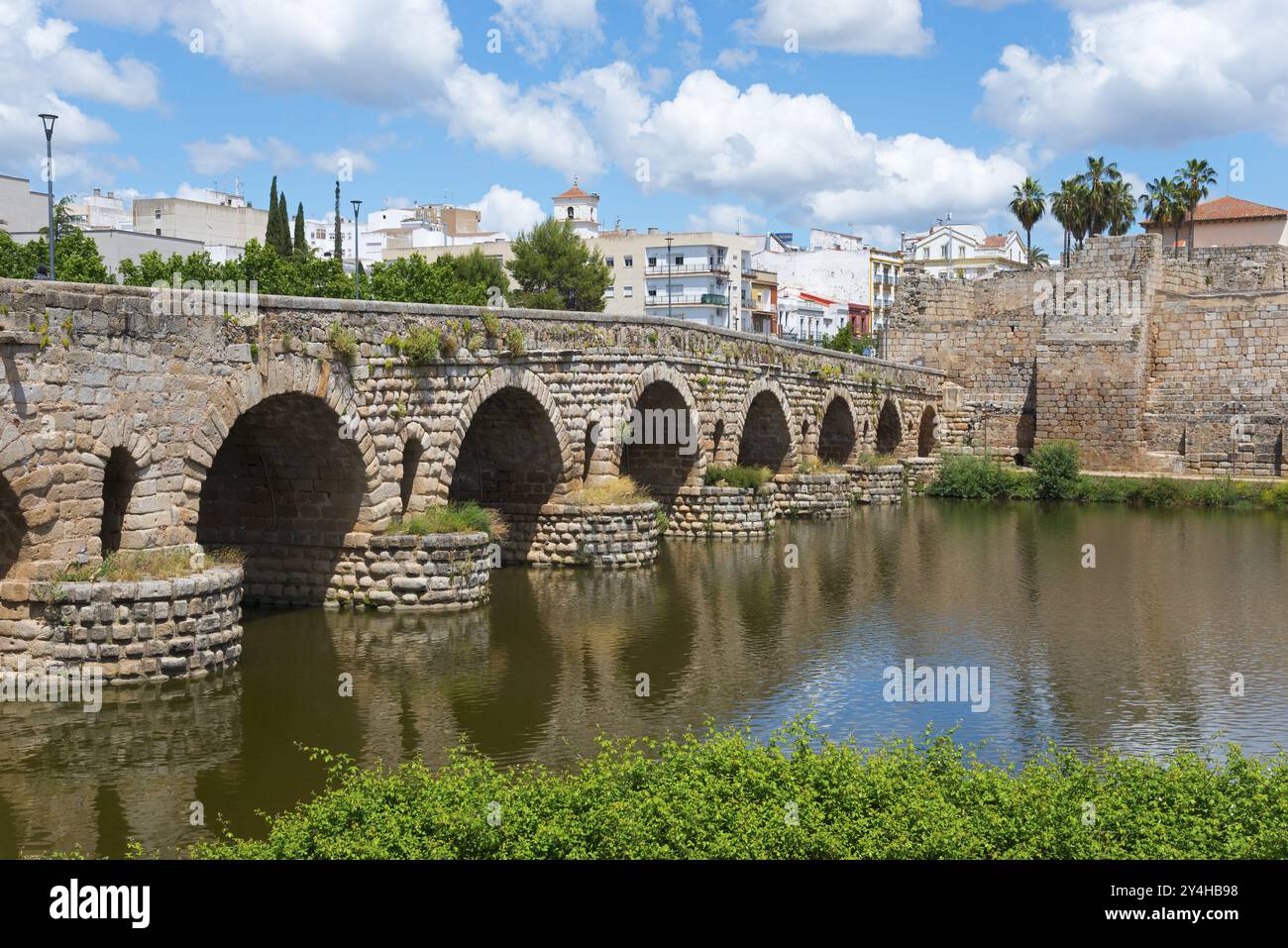 Historic stone bridge over a river with city wall in the background ...