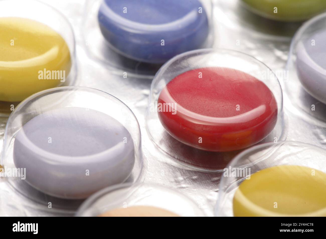 Colourful tablets packed in plastic, tablet addiction, drug addiction ...