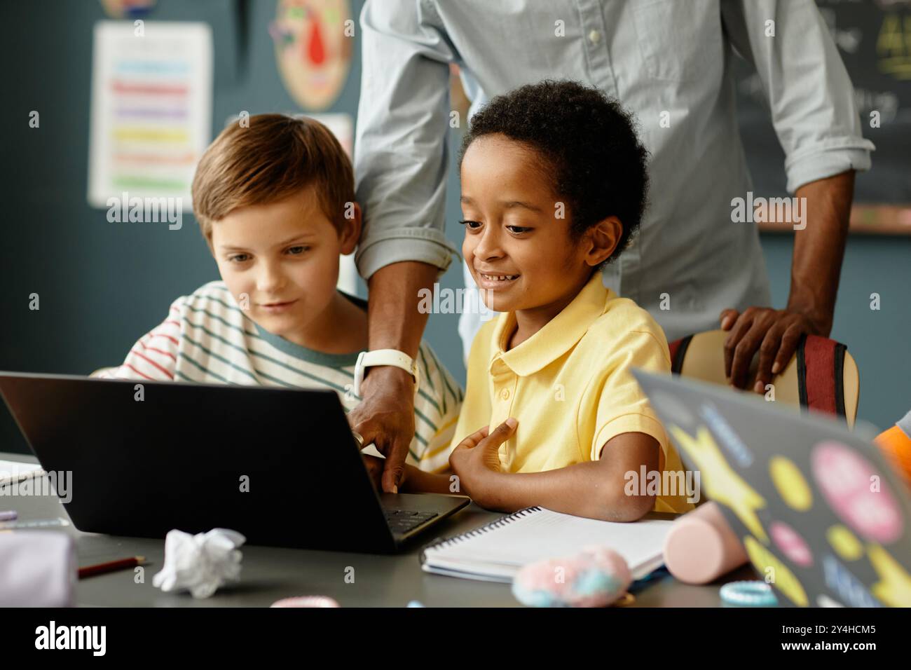 Medium shot of young African American boy with adorable smile using ...