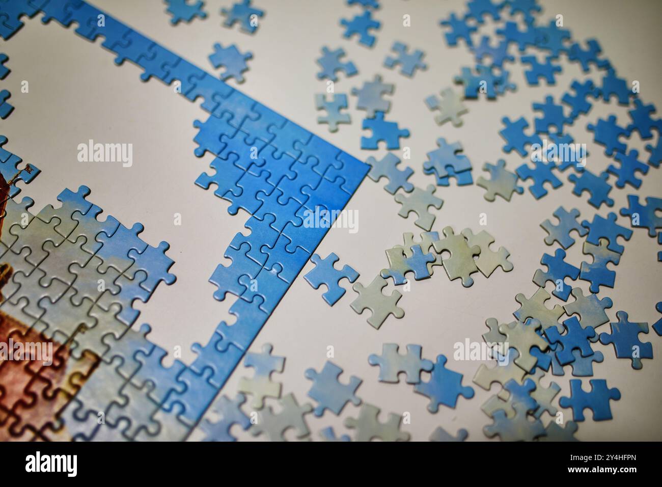 Connecting jigsaw puzzle pieces, fun family activity Stock Photo - Alamy