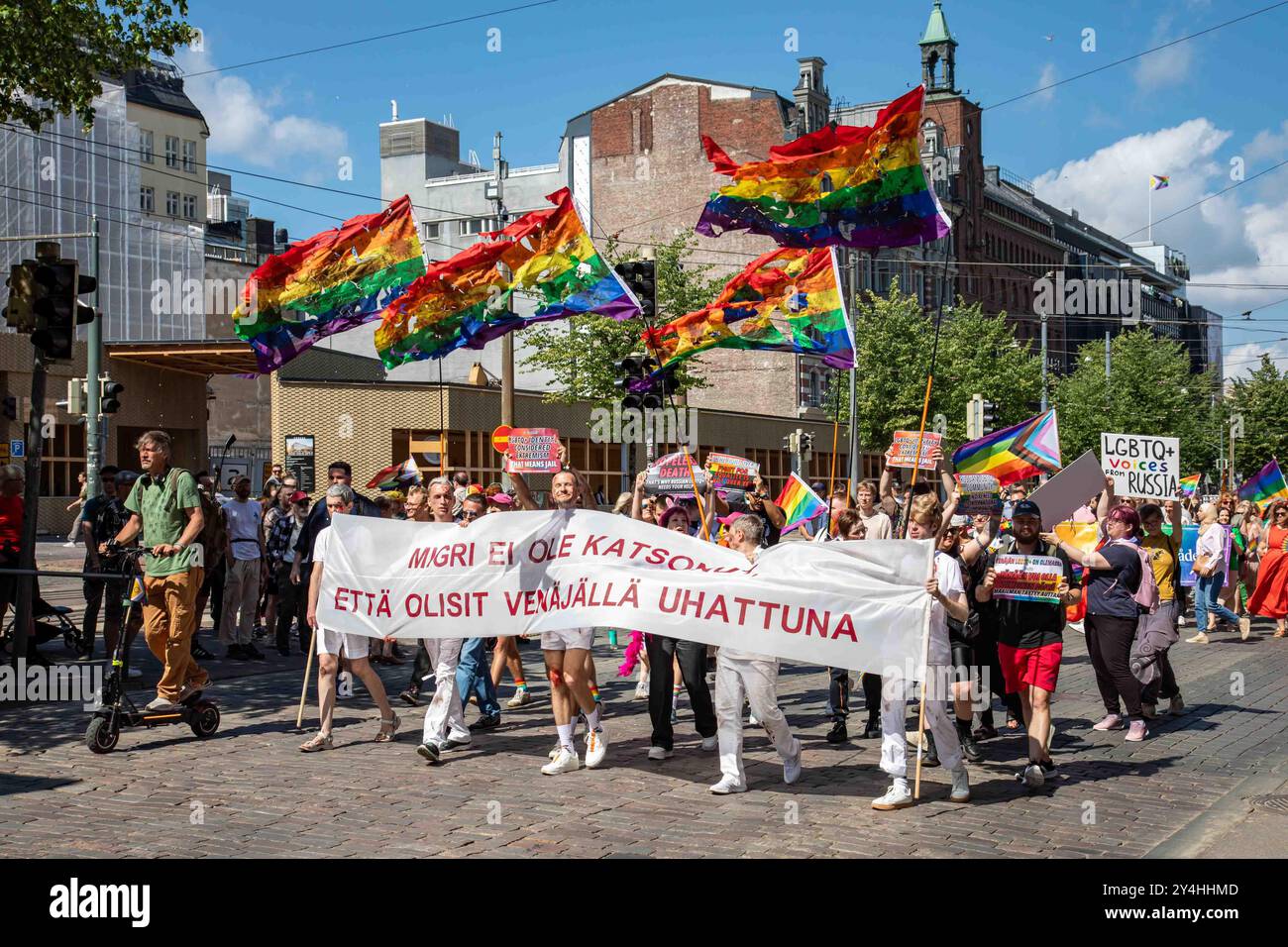 Russian LGBT asylum seekers marching with banner and torn rainbow flags ...