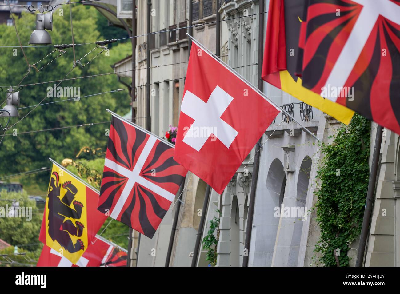 Various Swiss flags, for Bern, cantons, hanging from buildings in ...