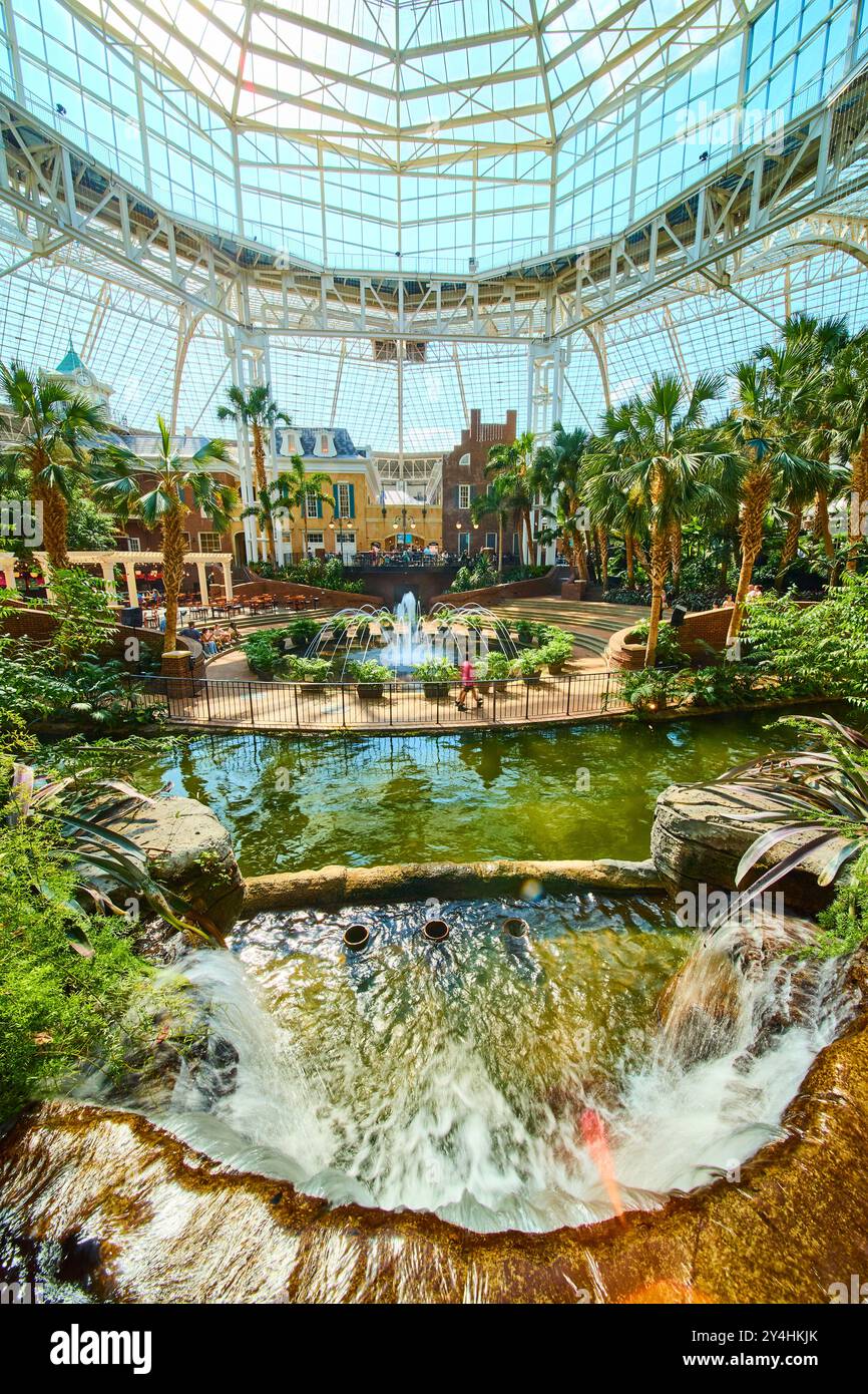 Tropical Atrium with Waterfall and Village Vibes Aerial Tilt Stock ...