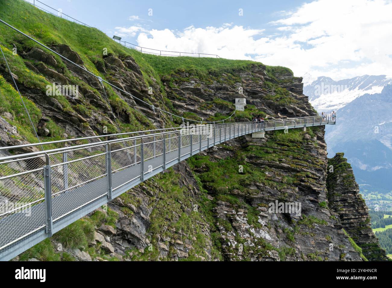 Grindelwald, Switzerland - July 20, 2024: Tourists walk on the ...