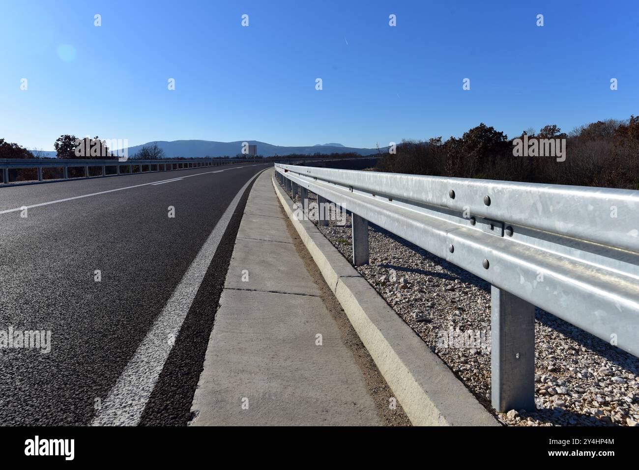 Metal fence for open road Stock Photo - Alamy