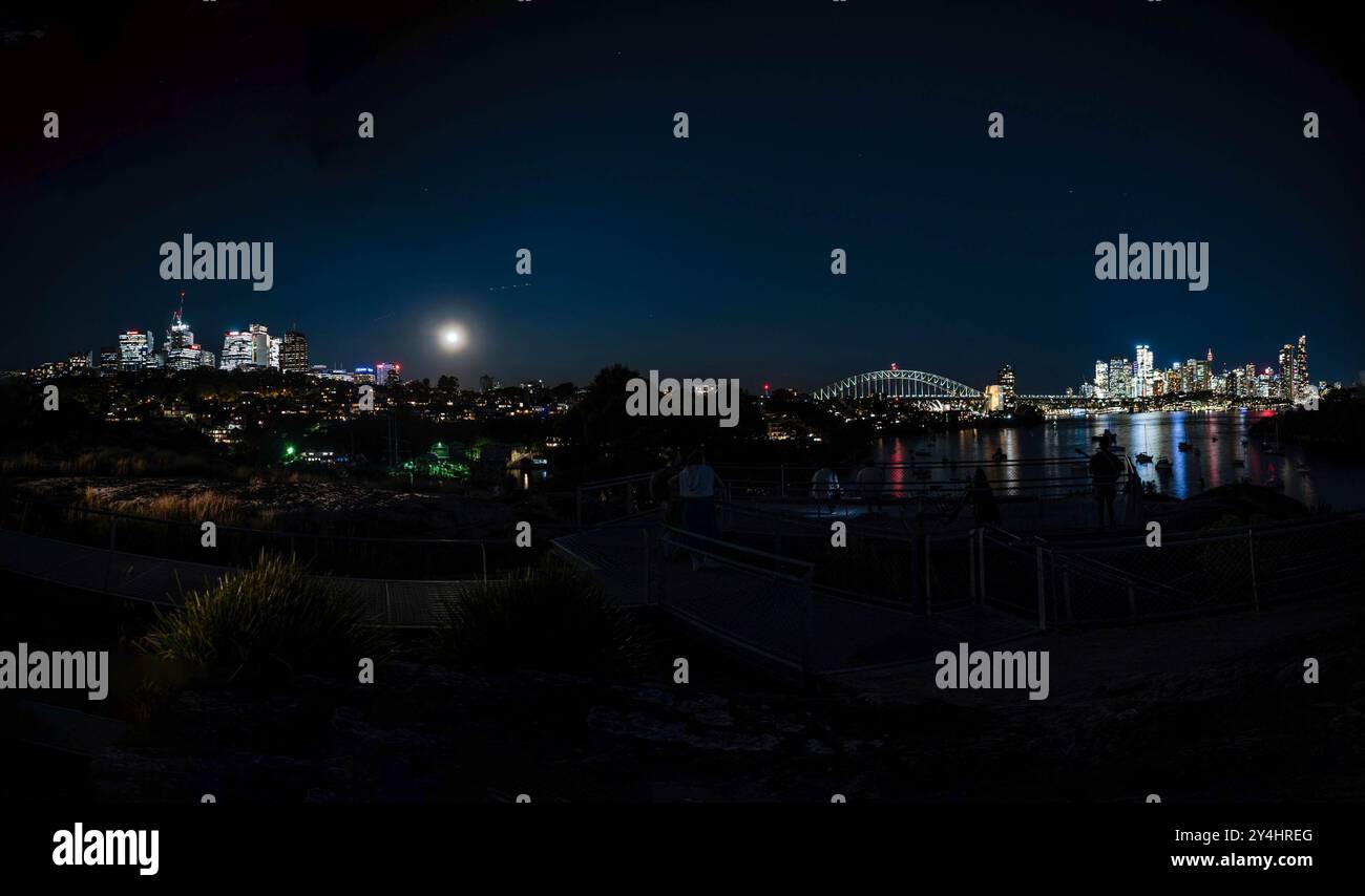 People gather at a lookout spot as the September Supermoon, also known ...