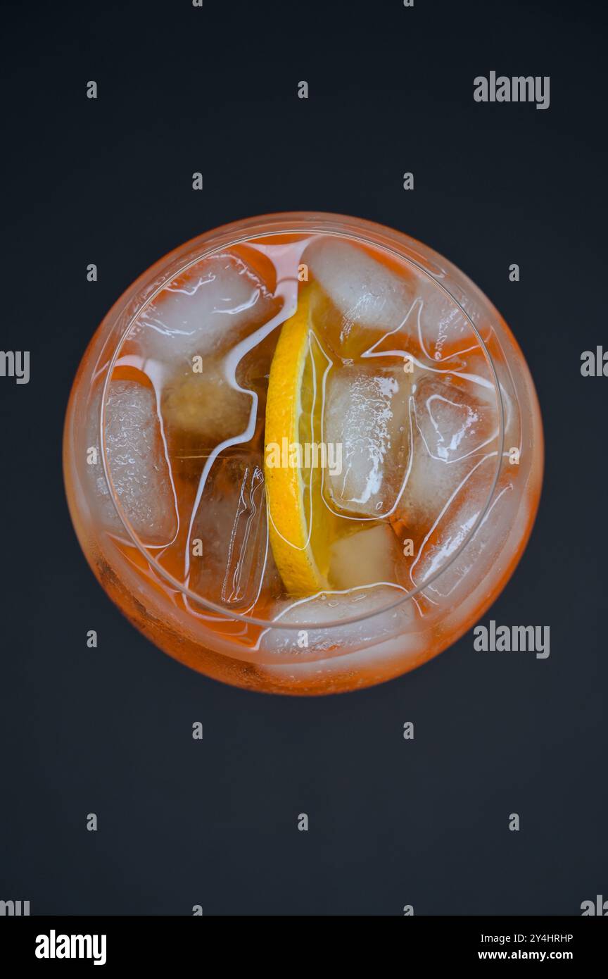 Top view orange cold drink with ice on black background Stock Photo - Alamy