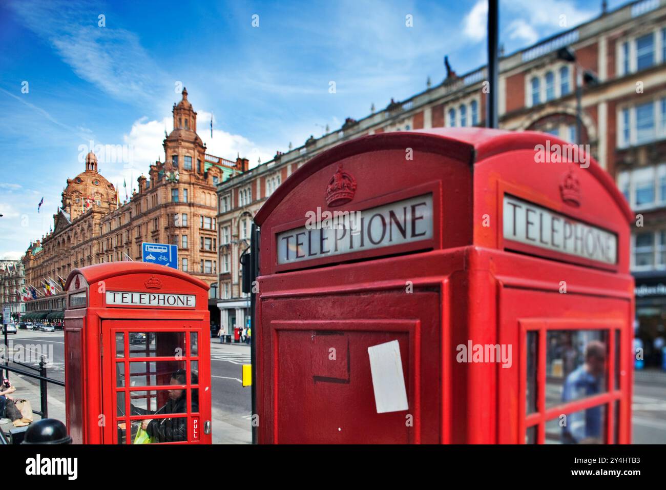 Two iconic red telephone boxes stand on Brompton Road near Harrods ...