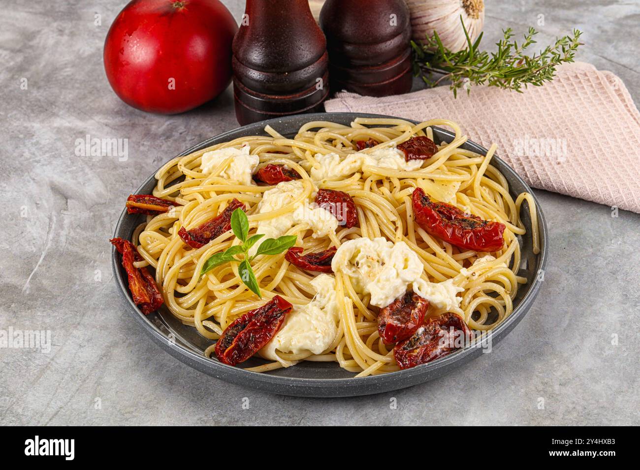 Italian pasta spaghetti with stracciatella and tomato Stock Photo - Alamy