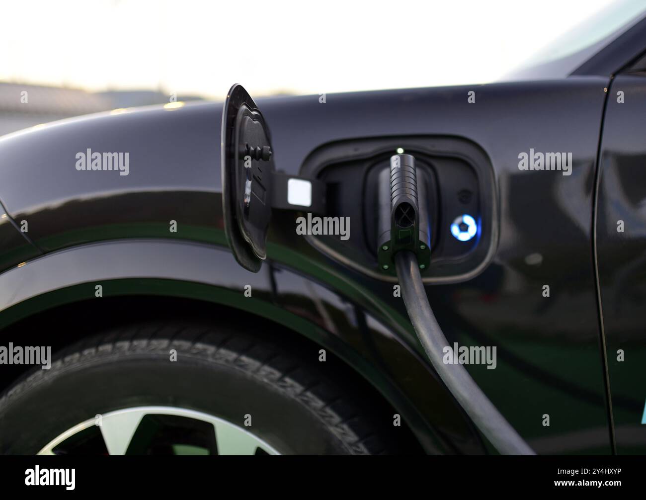 Connected charging connector to electric car. Loading energy of an ...