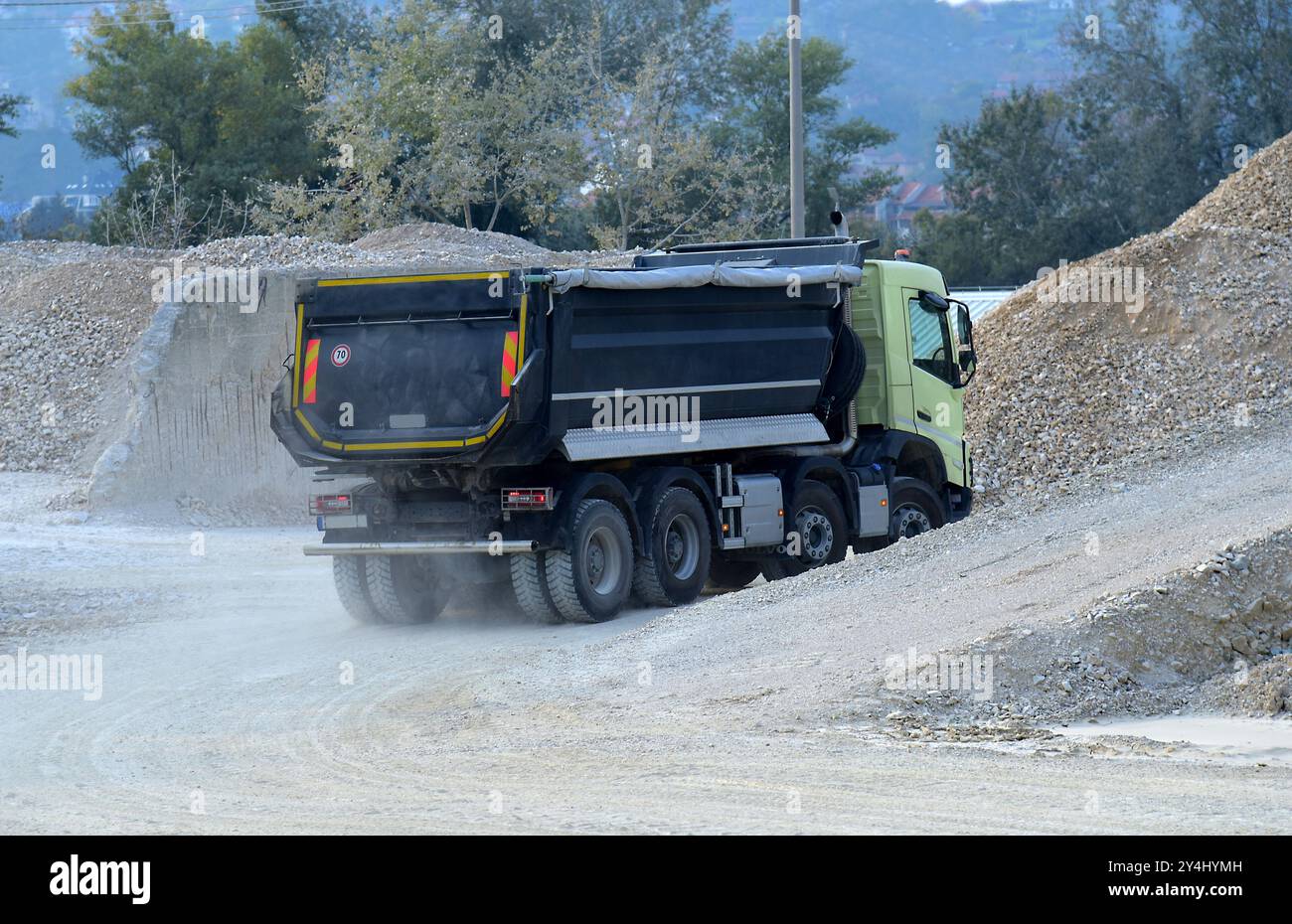 Big truck tipper drives in a quarry Stock Photo - Alamy
