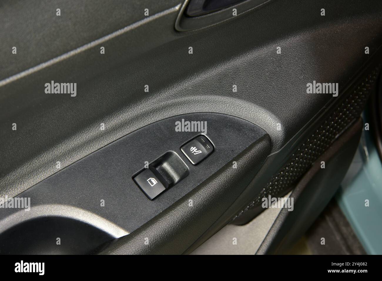 The button for raising the windows and the button for heating the seats ...