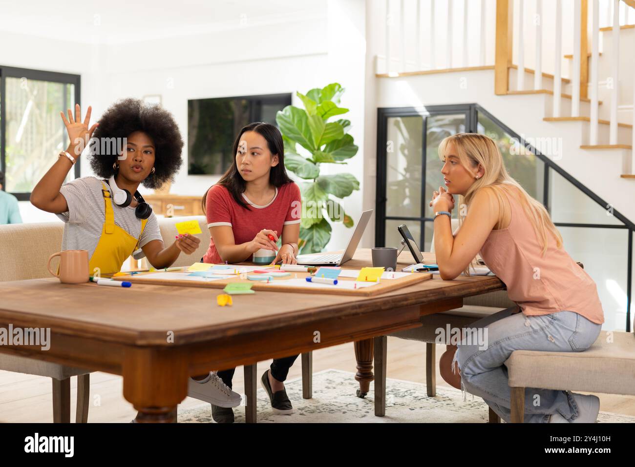 Collaborating on project, friends brainstorming ideas with notes and ...